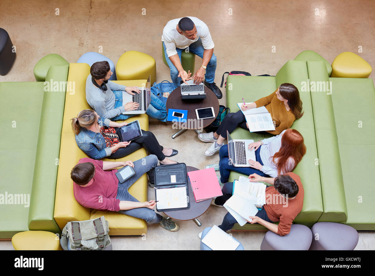 Overhead view of seven male and female students brainstorming in higher ...