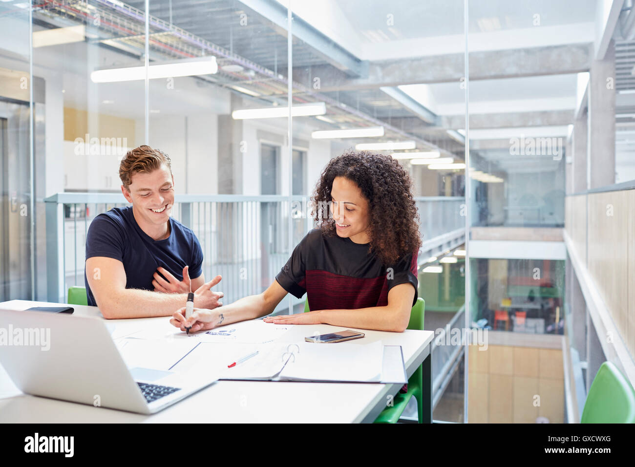Male and female designers brainstorming in design studio Stock Photo ...