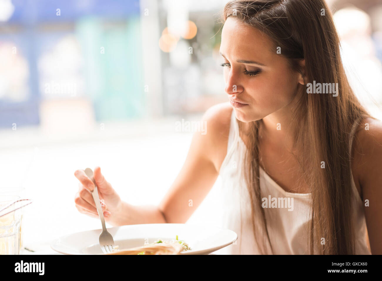 Young woman eating lunch in restaurant Stock Photo - Alamy