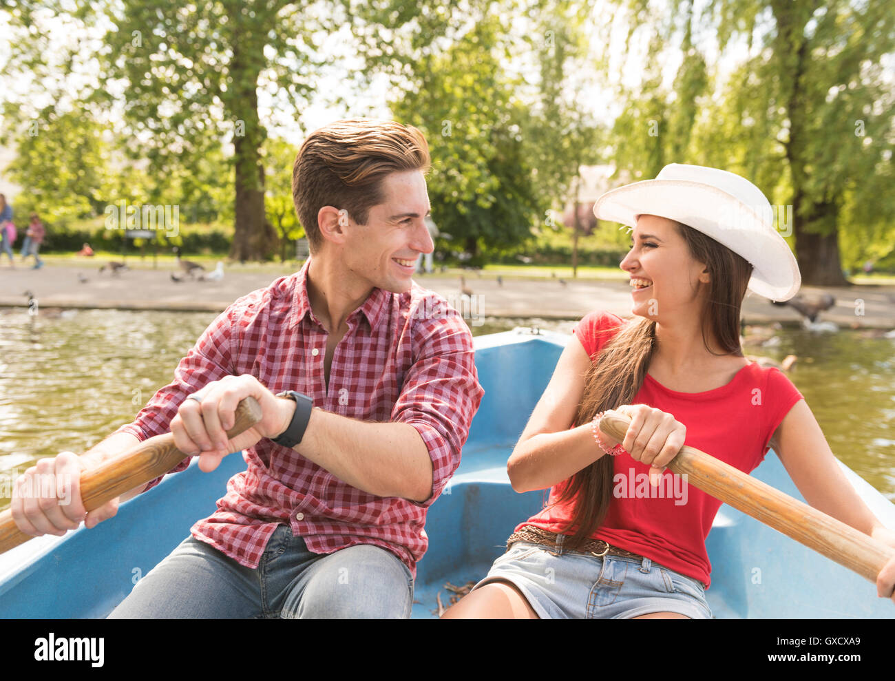 Young couple rowing a boat together in Regents Park, London, UK Stock ...