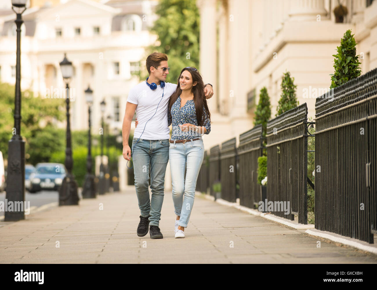 Young couple strolling on city street, London, UK Stock Photo - Alamy