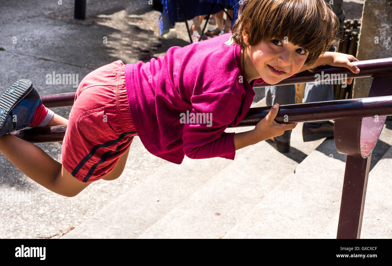 Portrait of boy sliding down stairway handrail Stock Photo - Alamy