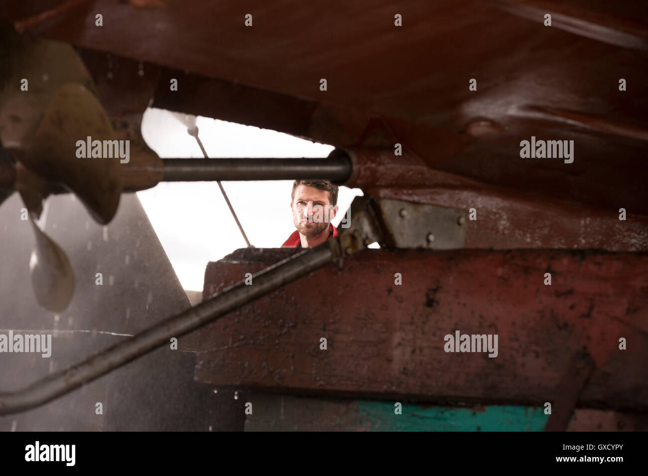 Male ship painter using pressure washer to clean ship hull Stock Photo ...