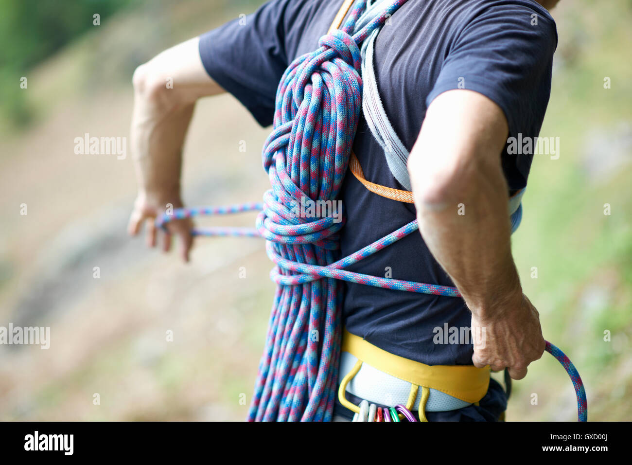 Cropped view of rock climber carrying climbing rope on back Stock Photo ...