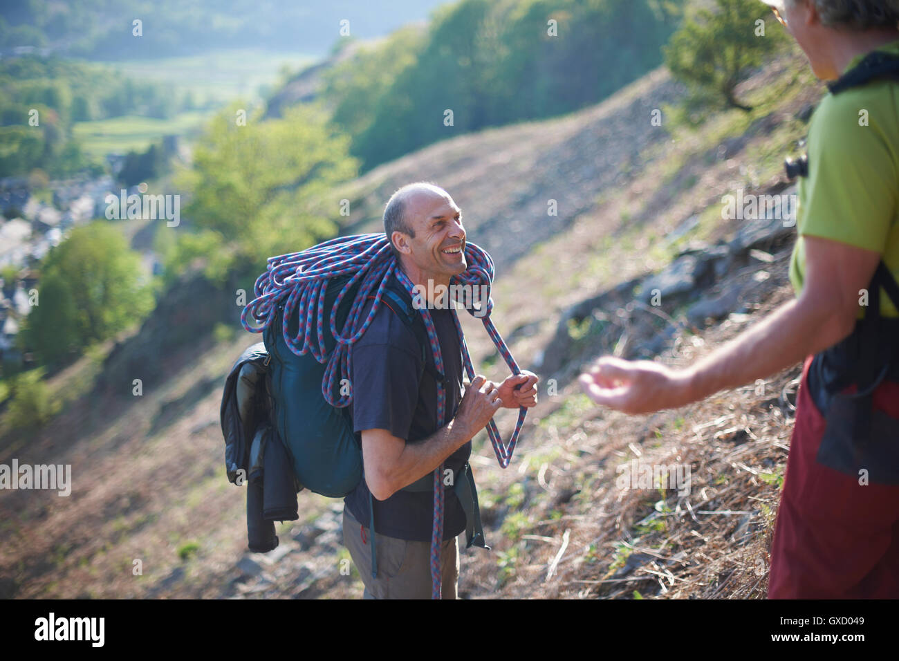 Rock climbers on hillside chatting and smiling Stock Photo - Alamy
