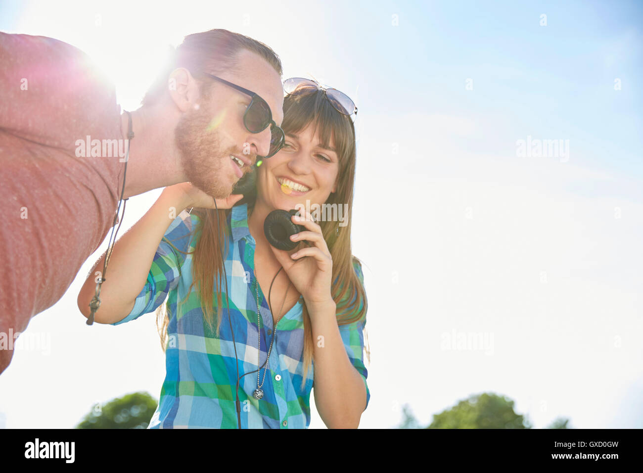 Couple sharing headphones hi-res stock photography and images - Alamy
