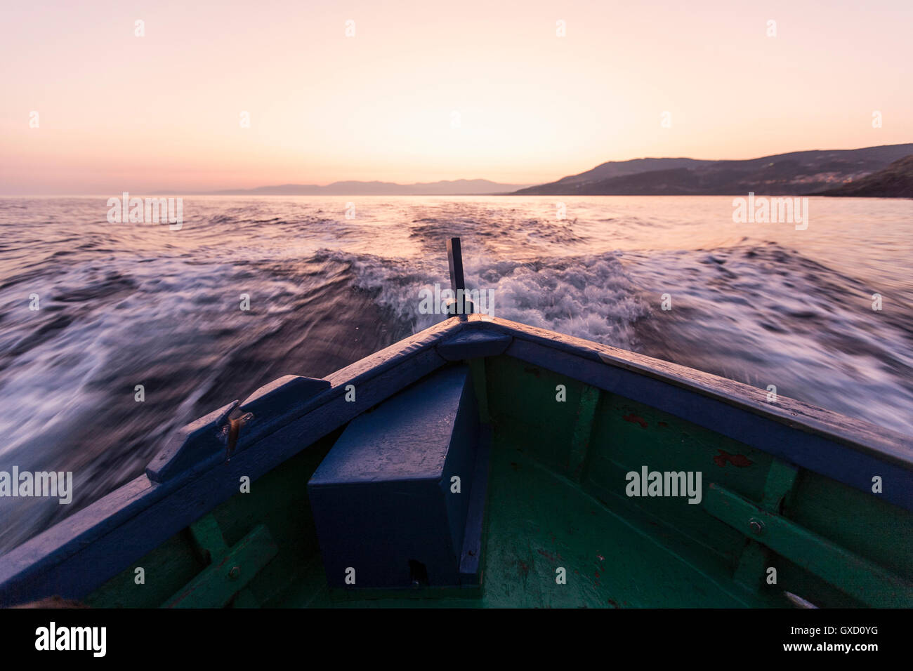 Boats bow on ocean waves at sunset, Capo Testa, Gallura, Sardinia ...