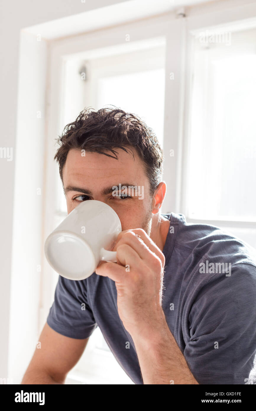 Man drinking from mug Stock Photo - Alamy