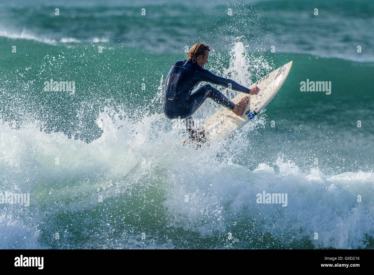 A surfer in spectacular action at Fistral in Newquay, Cornwall, England ...