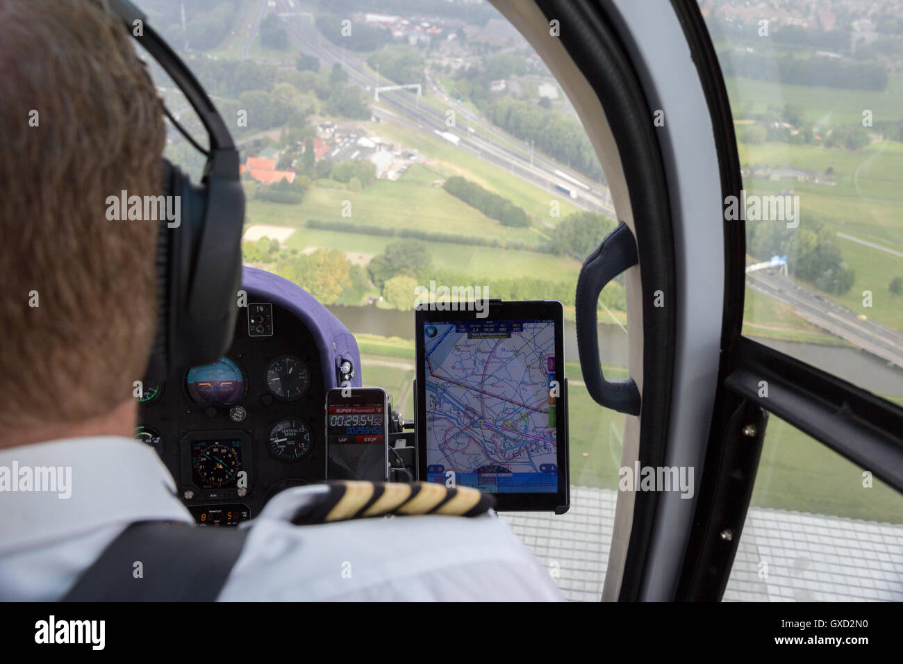 Helicopter pilot using tablet for chart navigation Stock Photo - Alamy