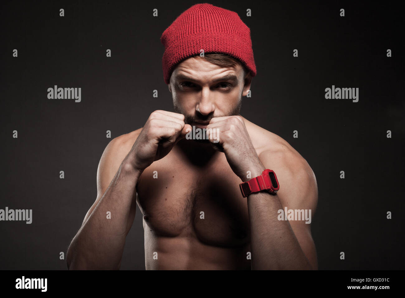 Fit young man in an aggressive pose Stock Photo - Alamy