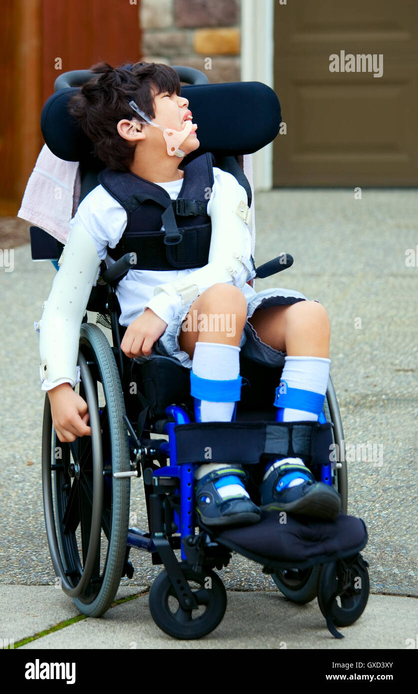 Seven year old biracial disabled boy in wheelchair Stock Photo - Alamy