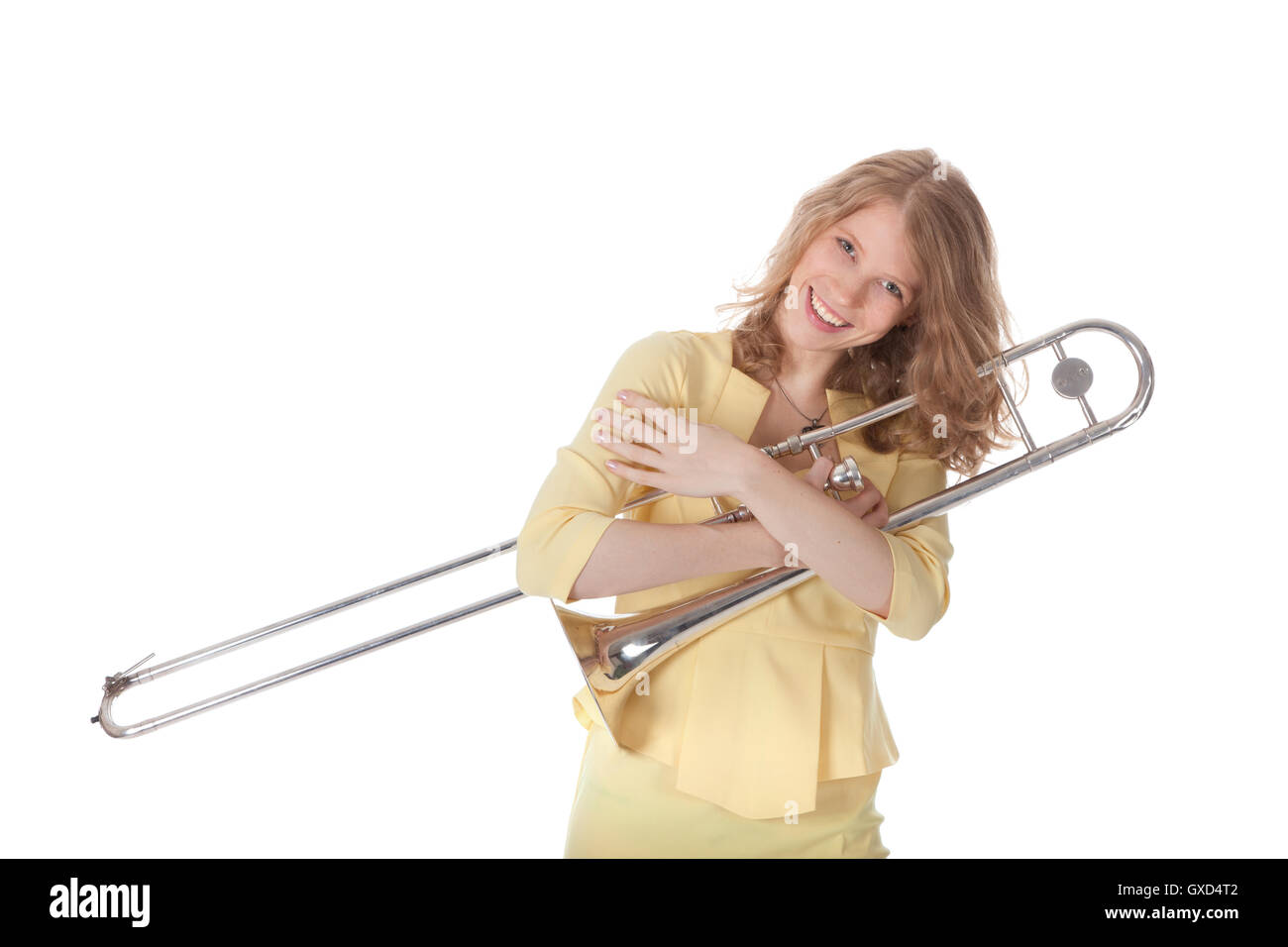 young woman in yellow holding trombone Stock Photo - Alamy