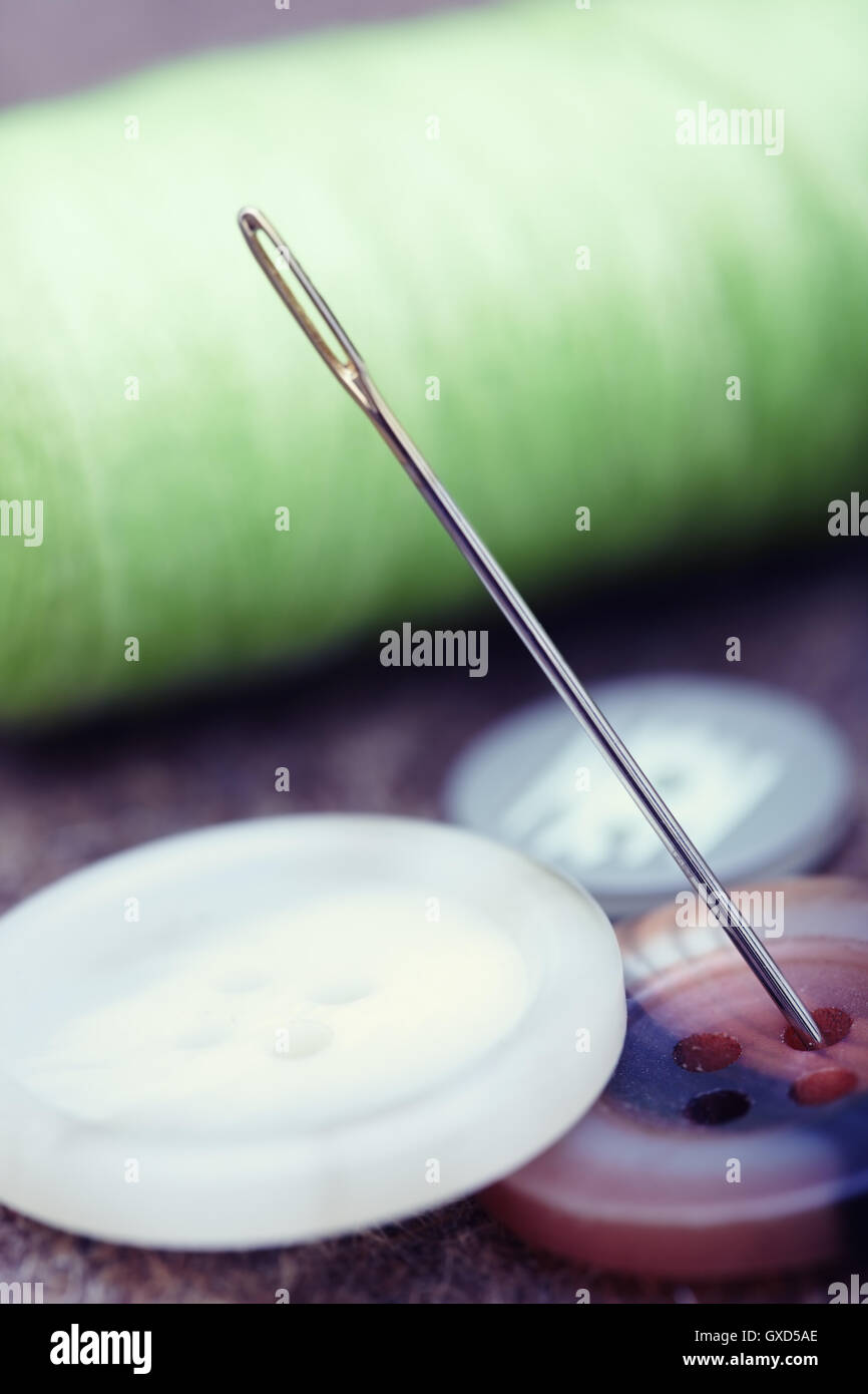 Buttons and sewing needle Stock Photo - Alamy