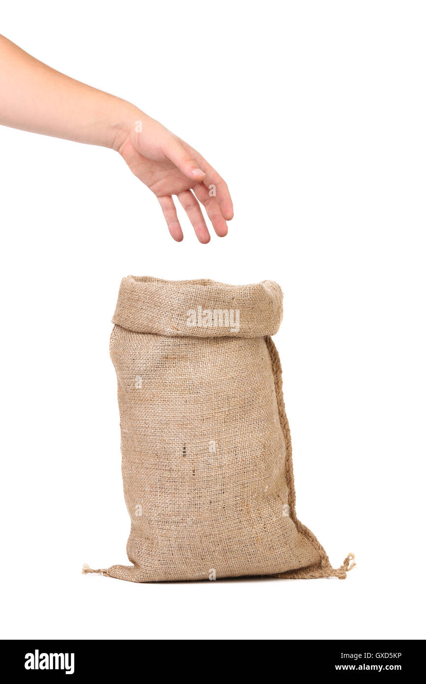 Hand picking up from full sack Stock Photo - Alamy