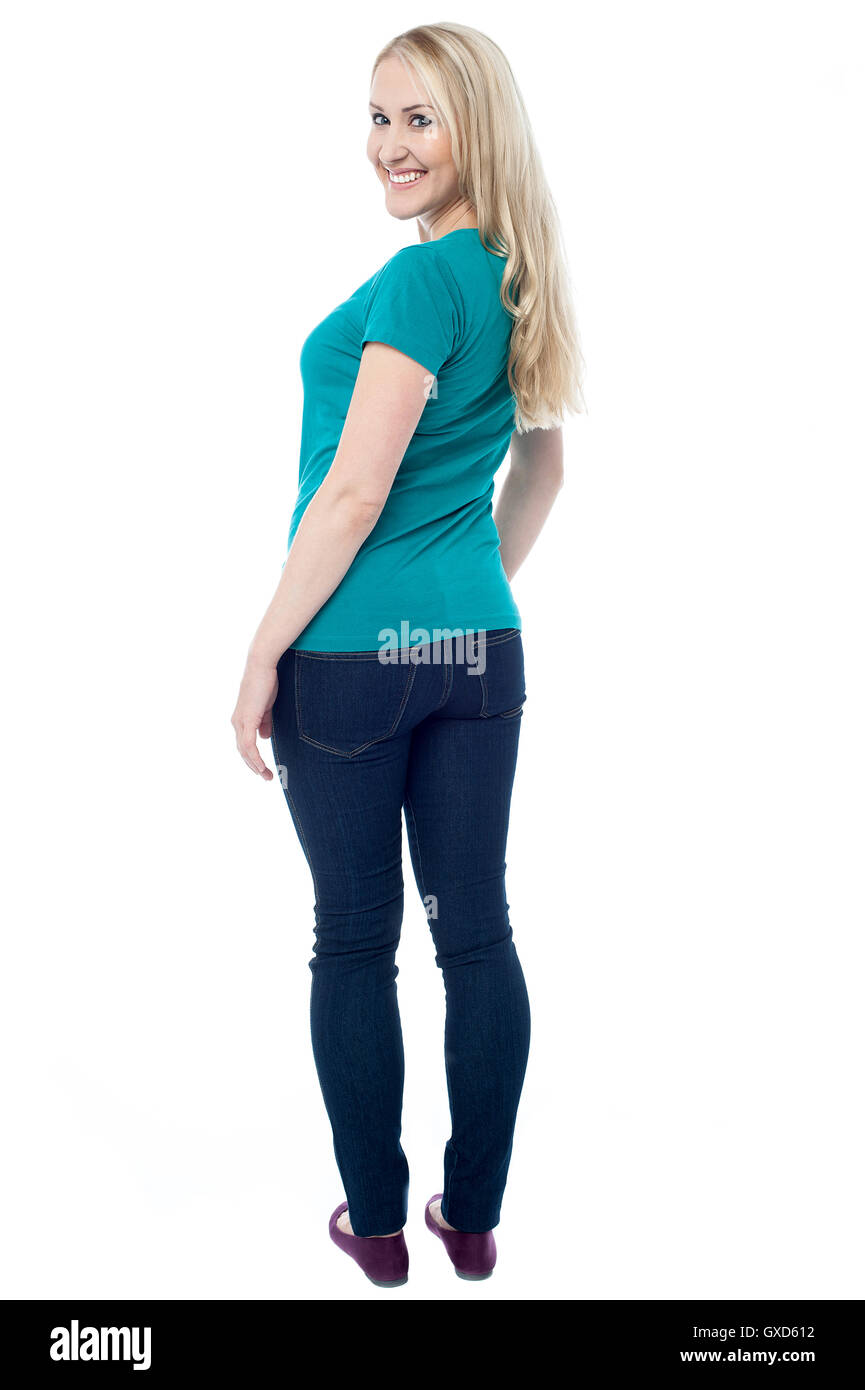 Attractive smiling lady turning back Stock Photo - Alamy