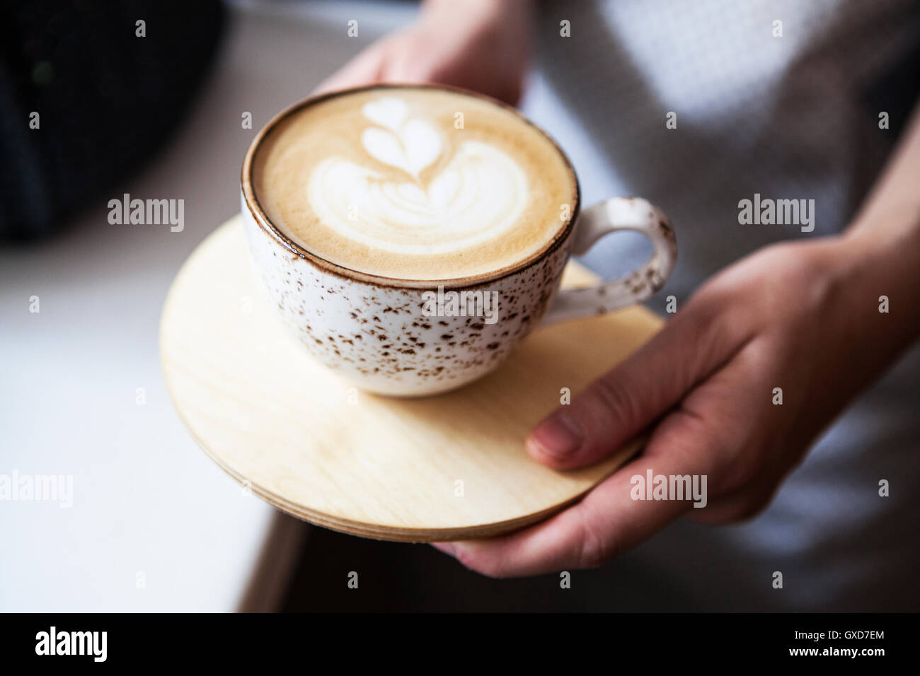 female hands holding Latte art, coffee cup Stock Photo - Alamy