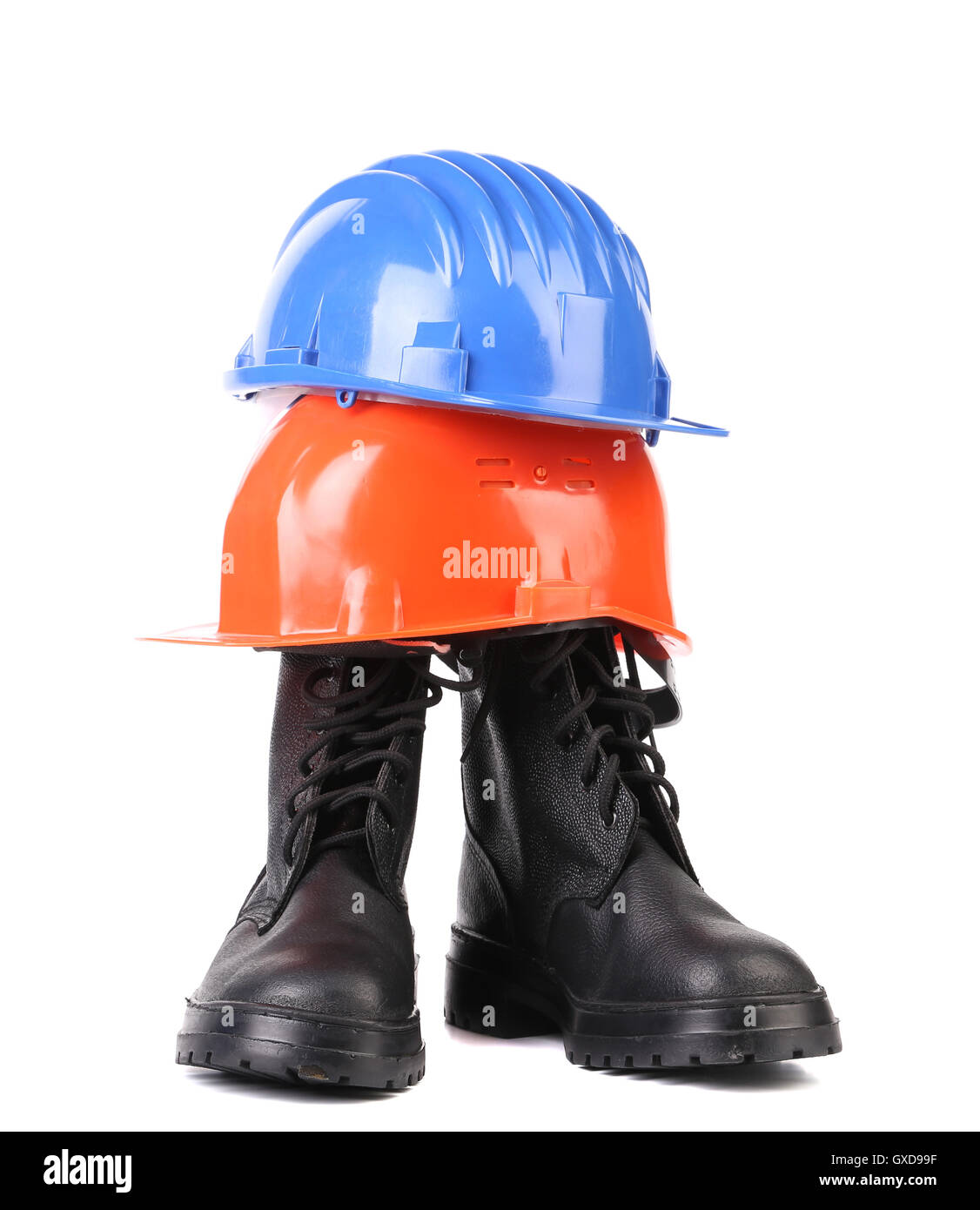 Hard hat and working boots Stock Photo - Alamy