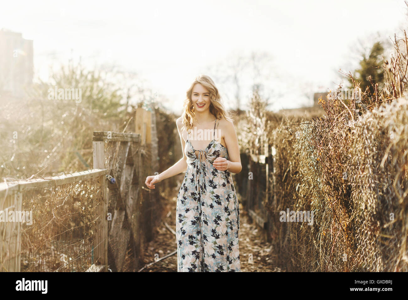 Young woman walking along rural farm pathway, smiling Stock Photo - Alamy