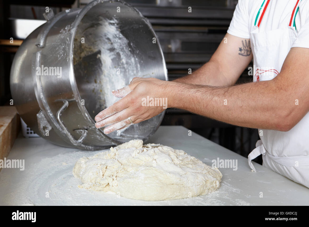 Baker in bakery, making bread Stock Photo - Alamy