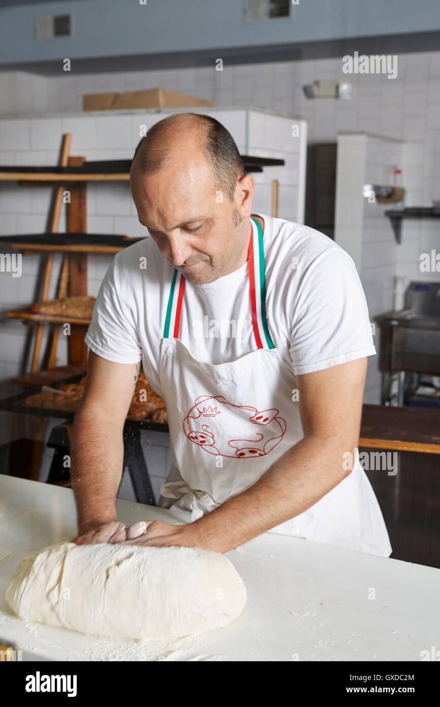 Baker in bakery, making bread Stock Photo - Alamy