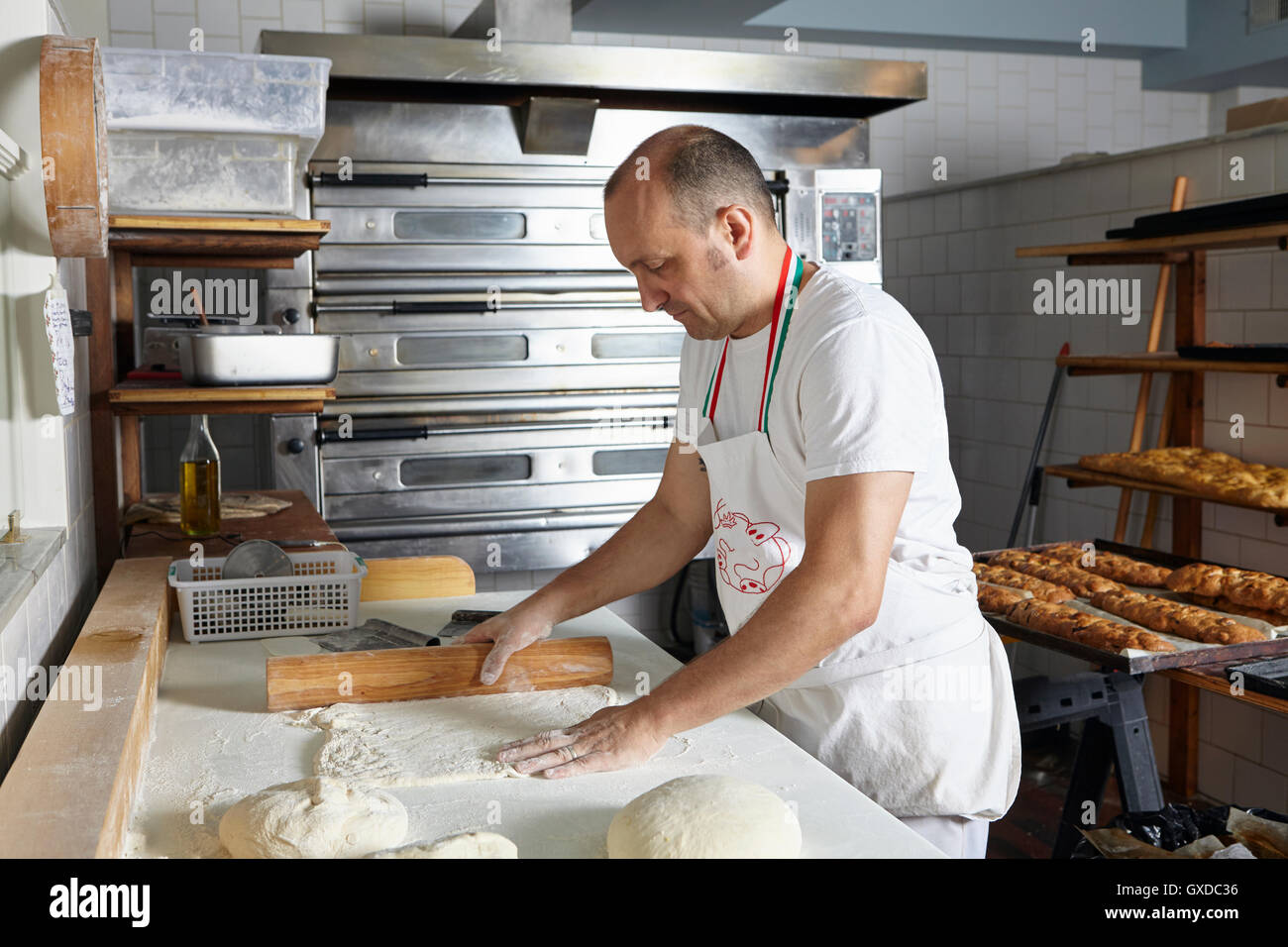 Baker working in bakery Stock Photo - Alamy