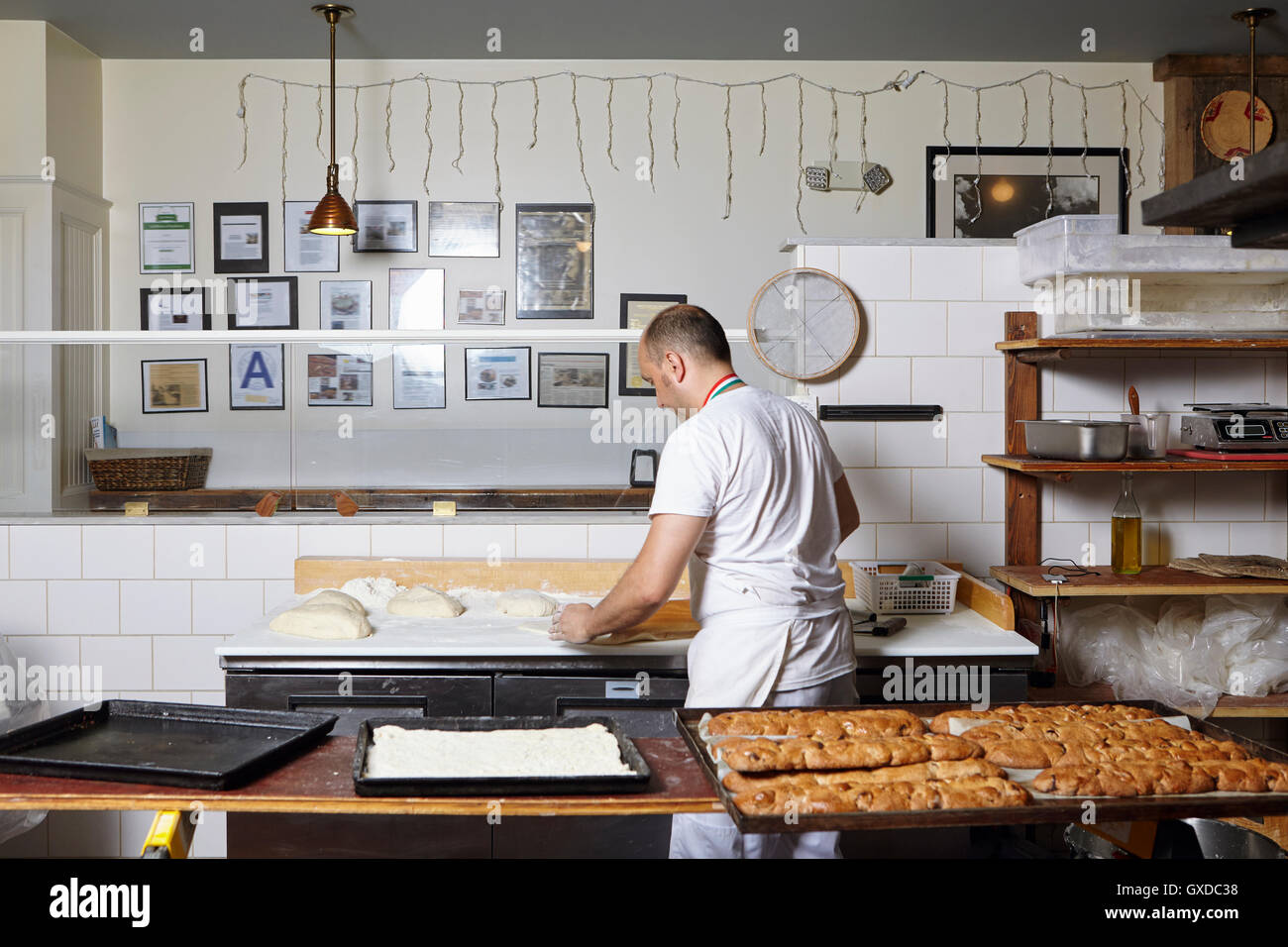 Baker working in bakery Stock Photo - Alamy