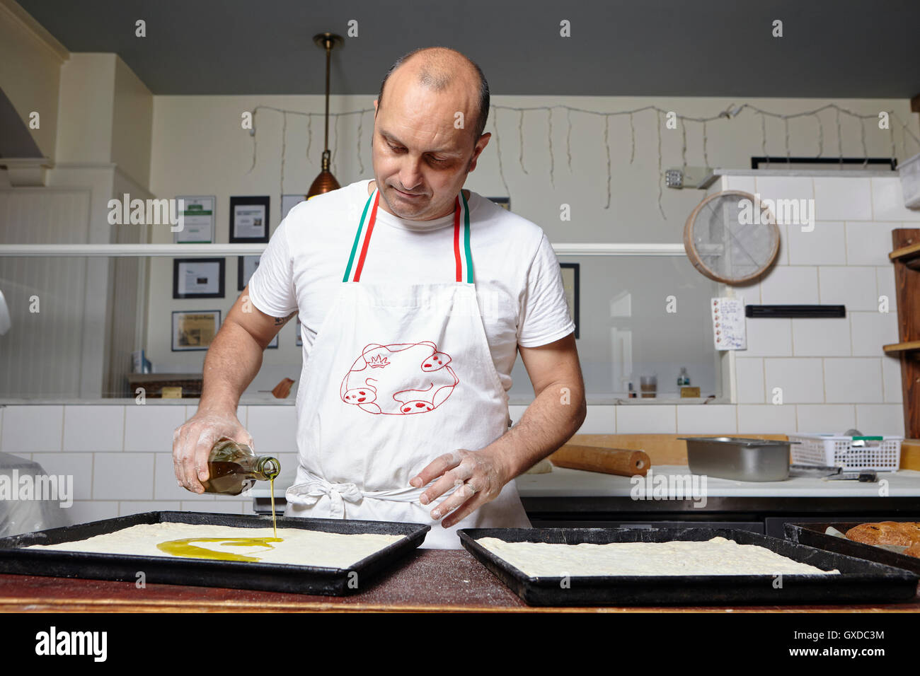 Baker working in bakery Stock Photo - Alamy
