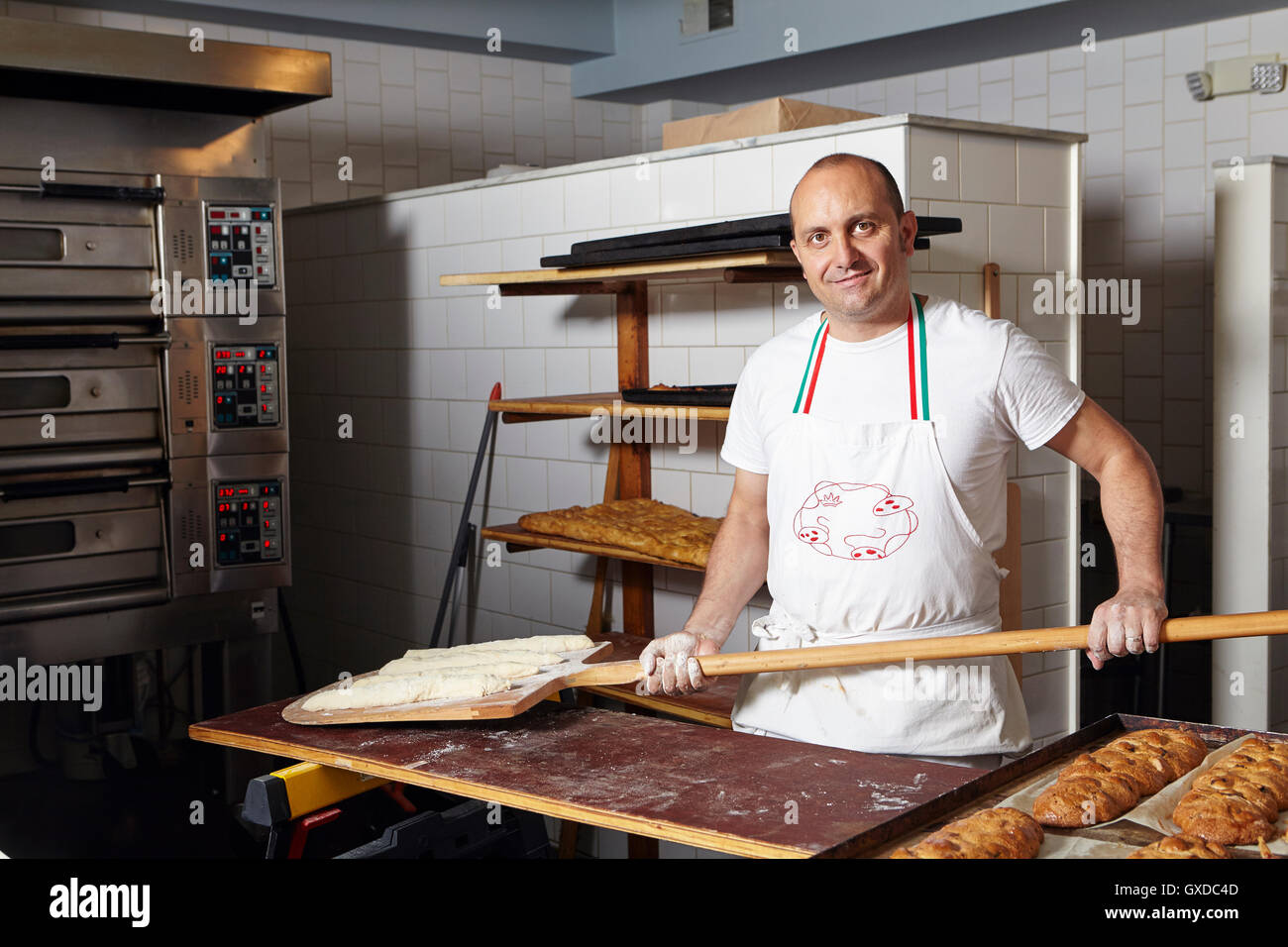 Baker working in bakery Stock Photo - Alamy