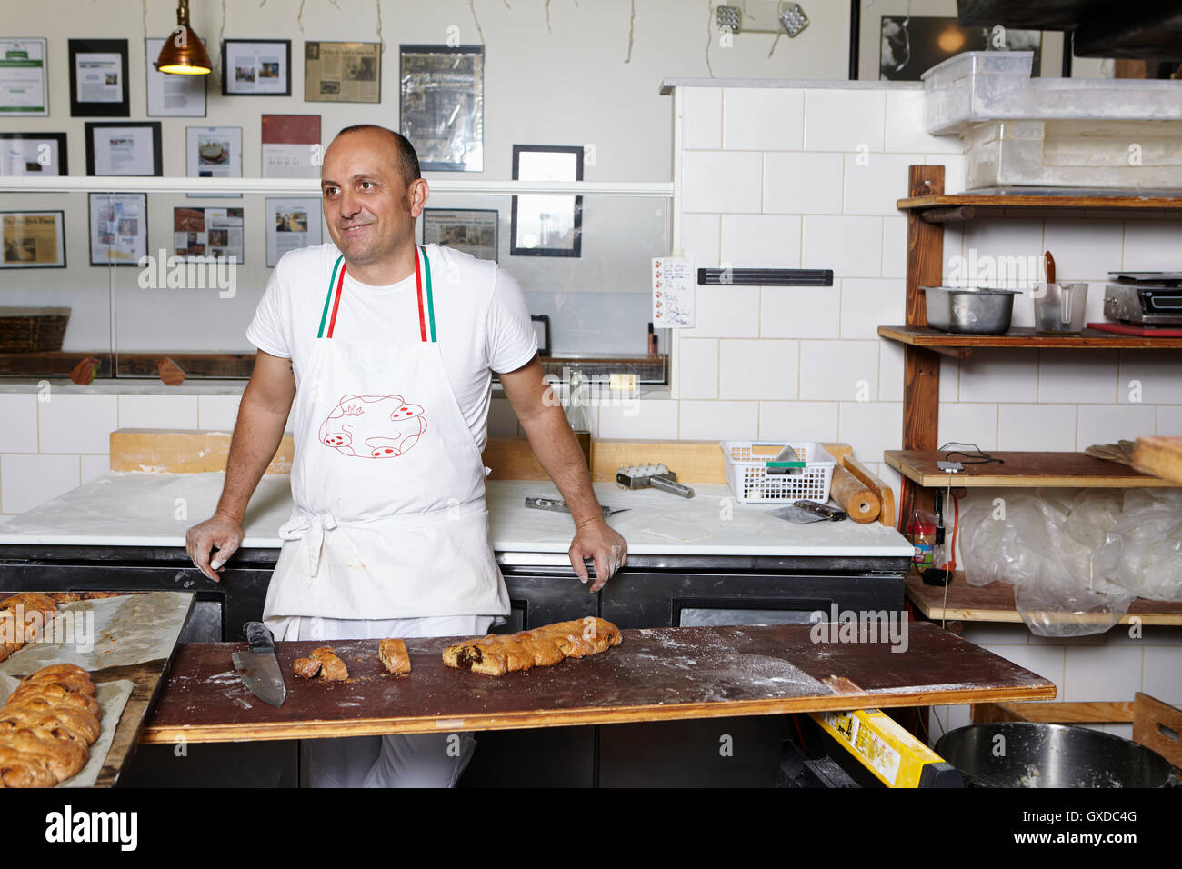Baker working in bakery Stock Photo - Alamy