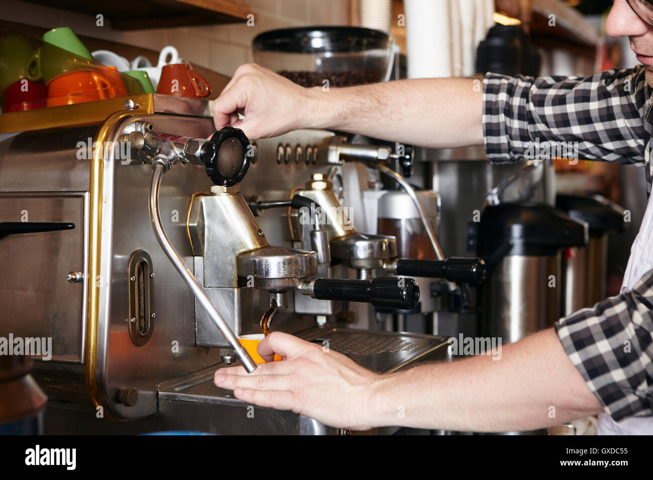 Male worker in bakery, using coffee machine, close-up Stock Photo - Alamy