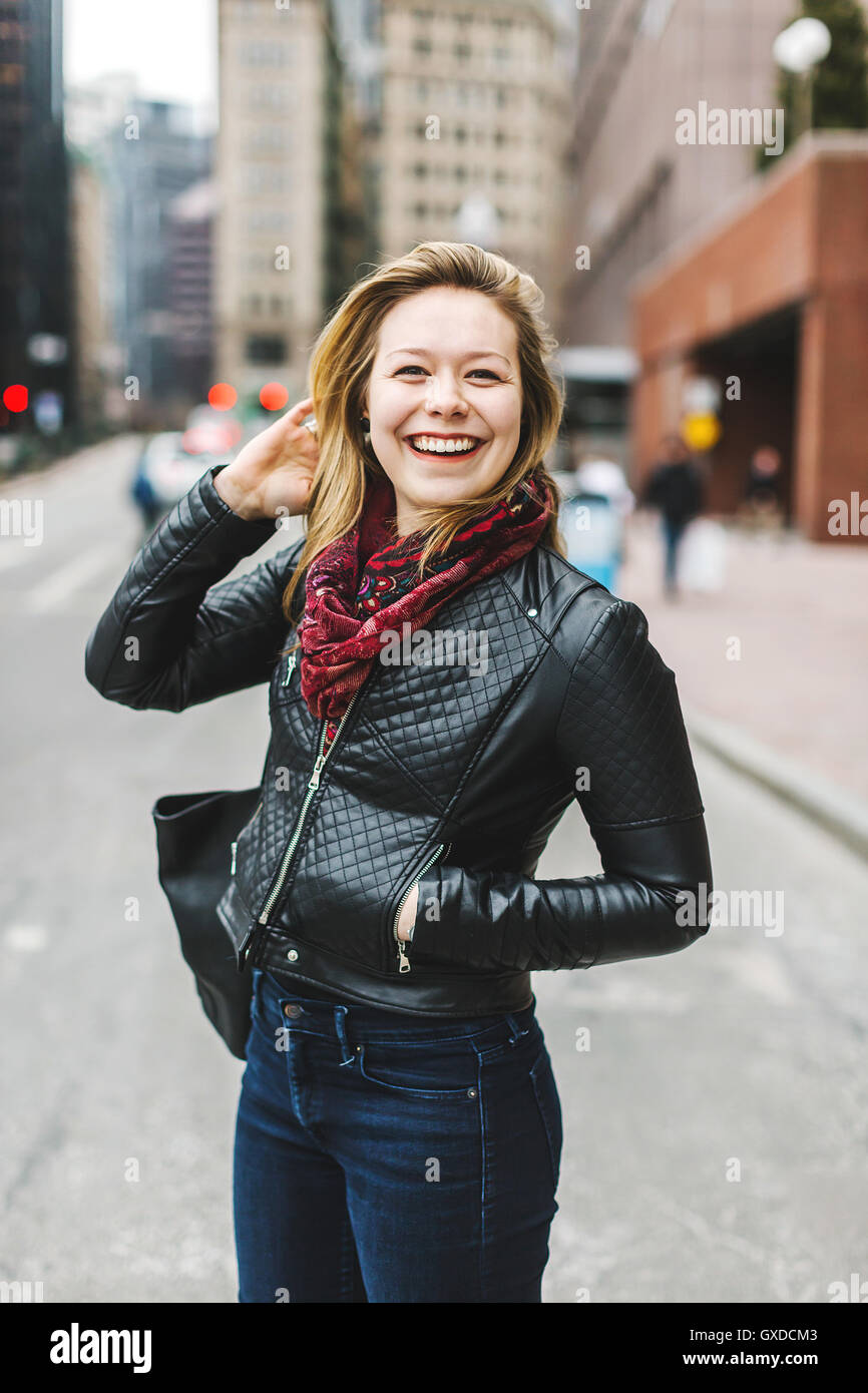 Portrait of woman in urban area looking at camera smiling, Boston ...