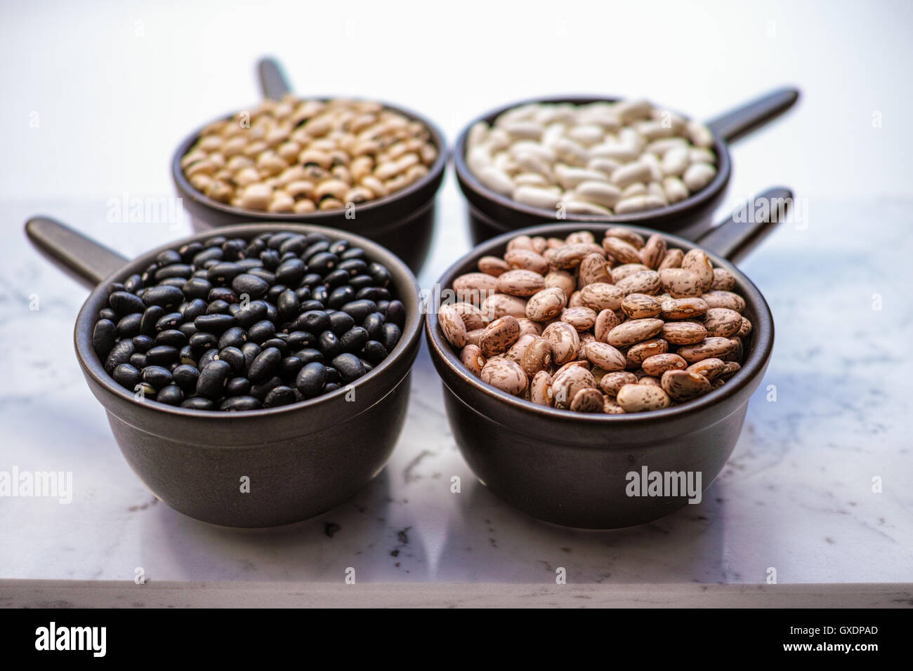 Beans variety/ different types of beans in ceramic bowls on black ...