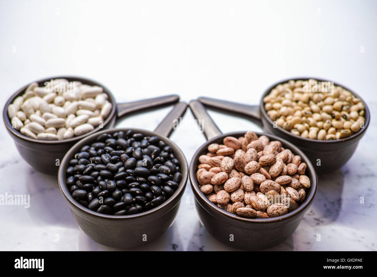 Beans variety/ different types of beans in ceramic bowls on black ...