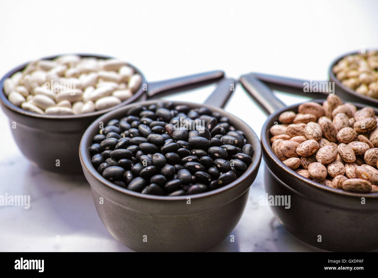 Beans variety/ different types of beans in ceramic bowls on black ...