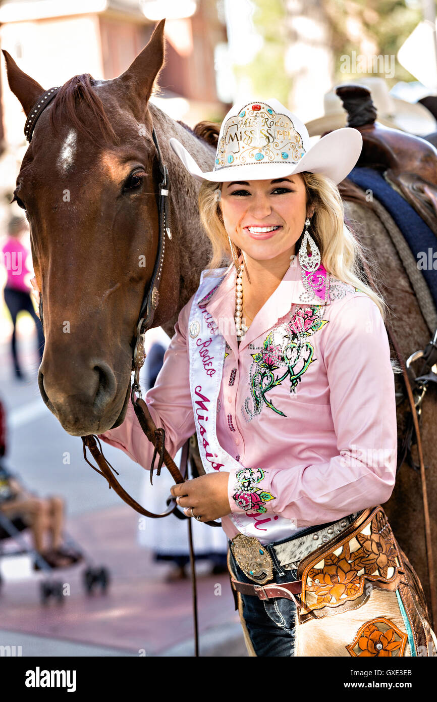 A young woman in cowboy hat smiles during the Cheyenne Frontier Days ...