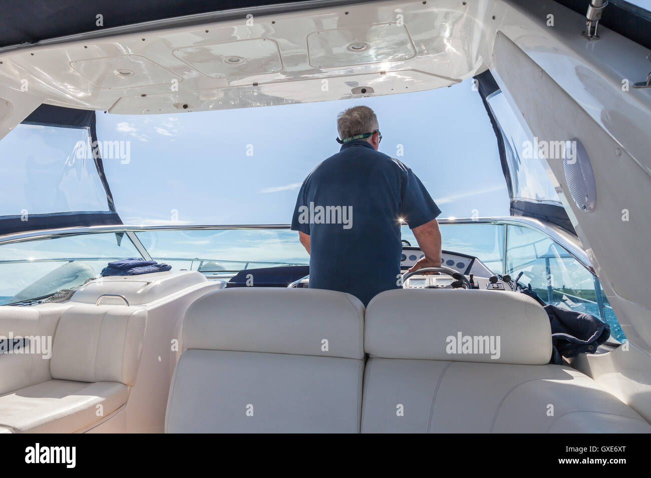 Captain of a Motor Cruiser taking her out to sea Stock Photo - Alamy
