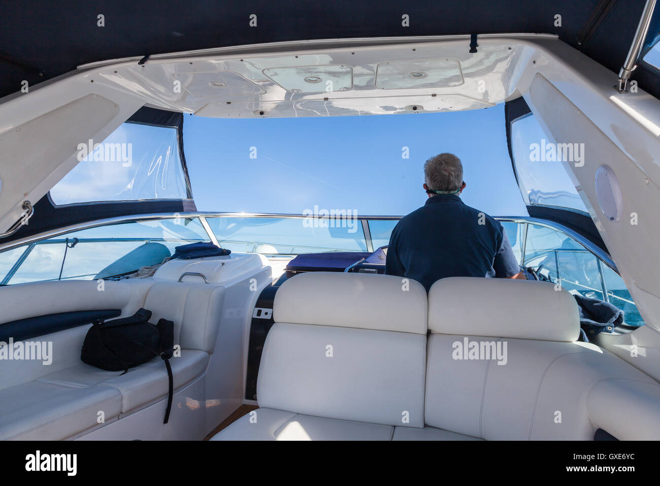 Captain of a Motor Cruiser taking her out to sea Stock Photo - Alamy