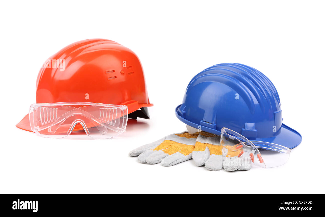 Two hard hats with working gloves Stock Photo - Alamy