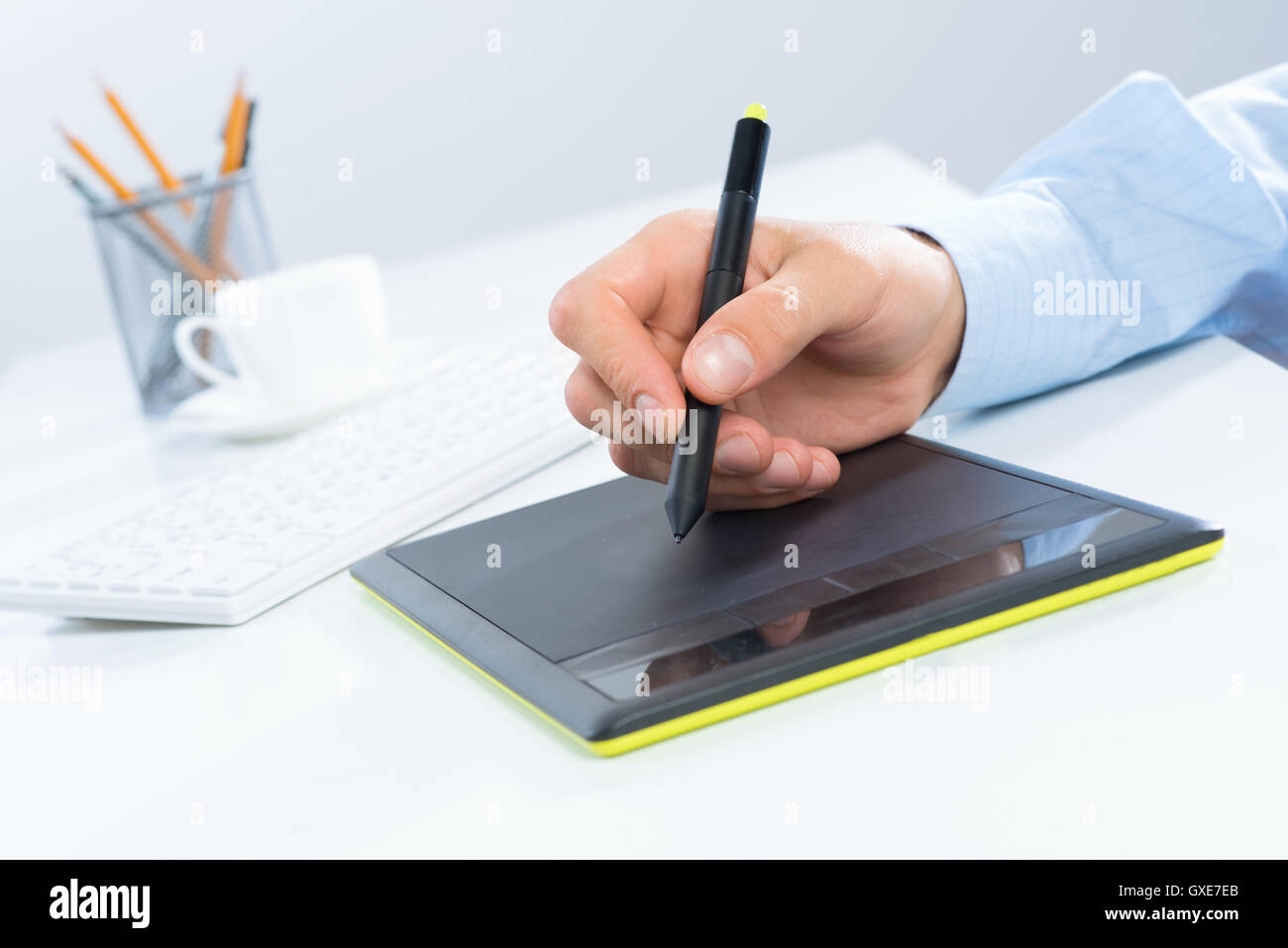 Designer hand drawing a graph on the tablet Stock Photo - Alamy