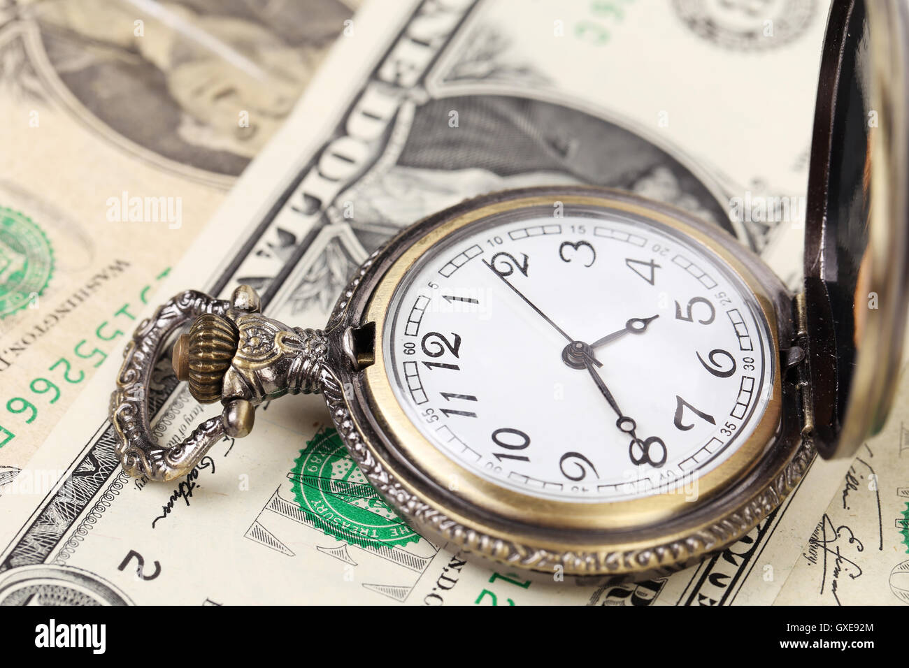 Pocket watch with financial assets Stock Photo - Alamy