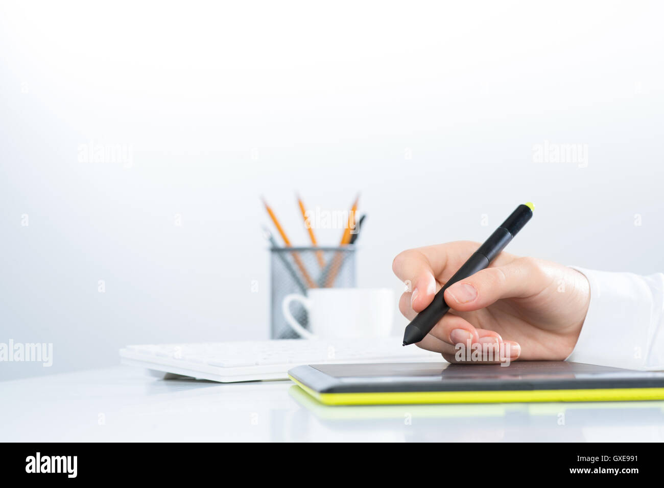 Designer hand drawing a graph on the tablet Stock Photo - Alamy
