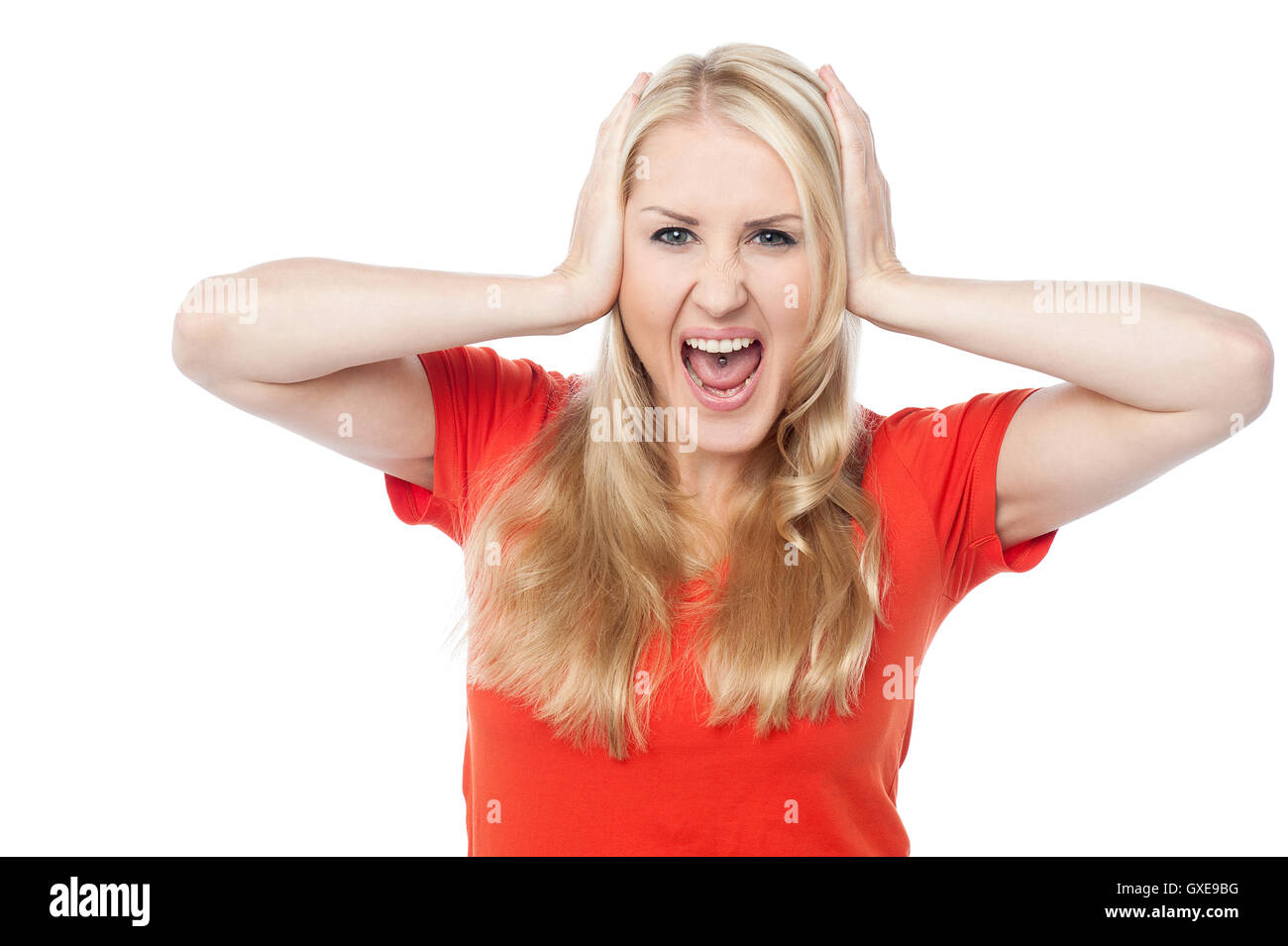 Screaming young woman holding her head Stock Photo - Alamy