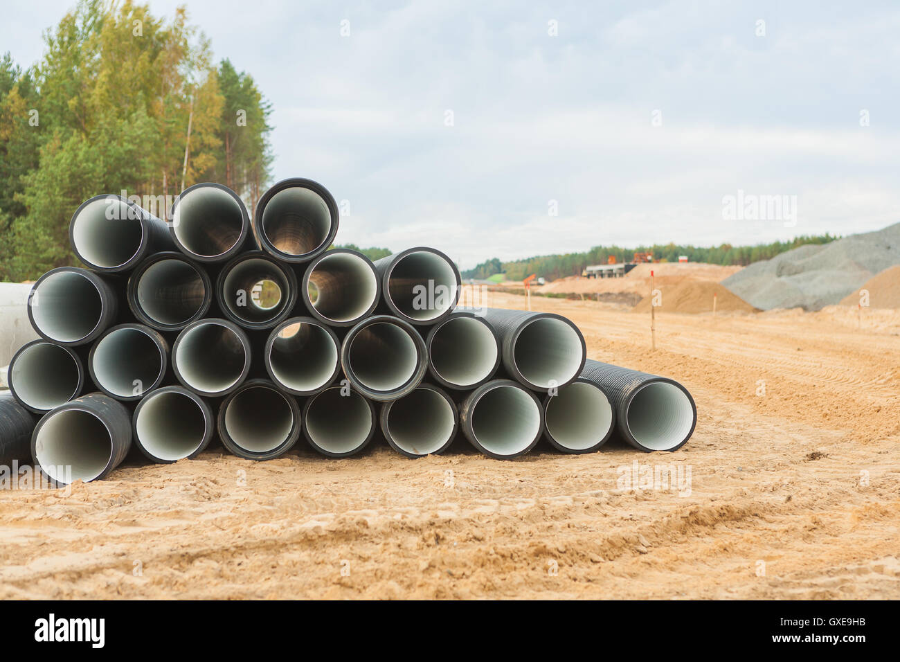 stack of big pipes on construction place Stock Photo - Alamy