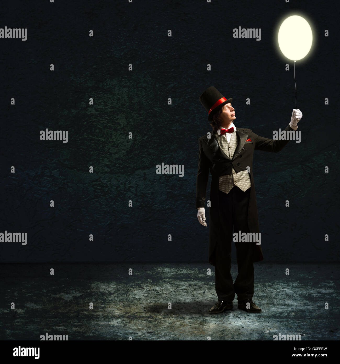 magician holding a glowing balloon Stock Photo - Alamy