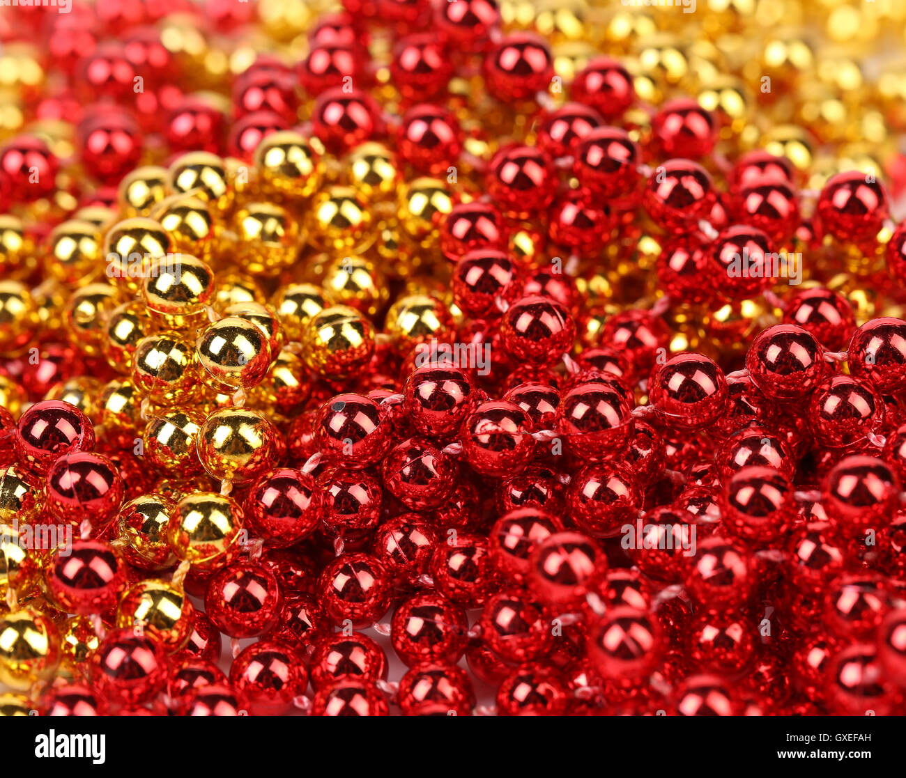 Gold and red beads Stock Photo - Alamy