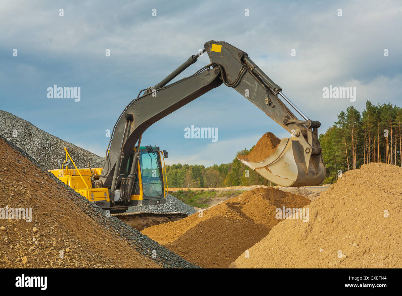 excavator moving sand Stock Photo - Alamy