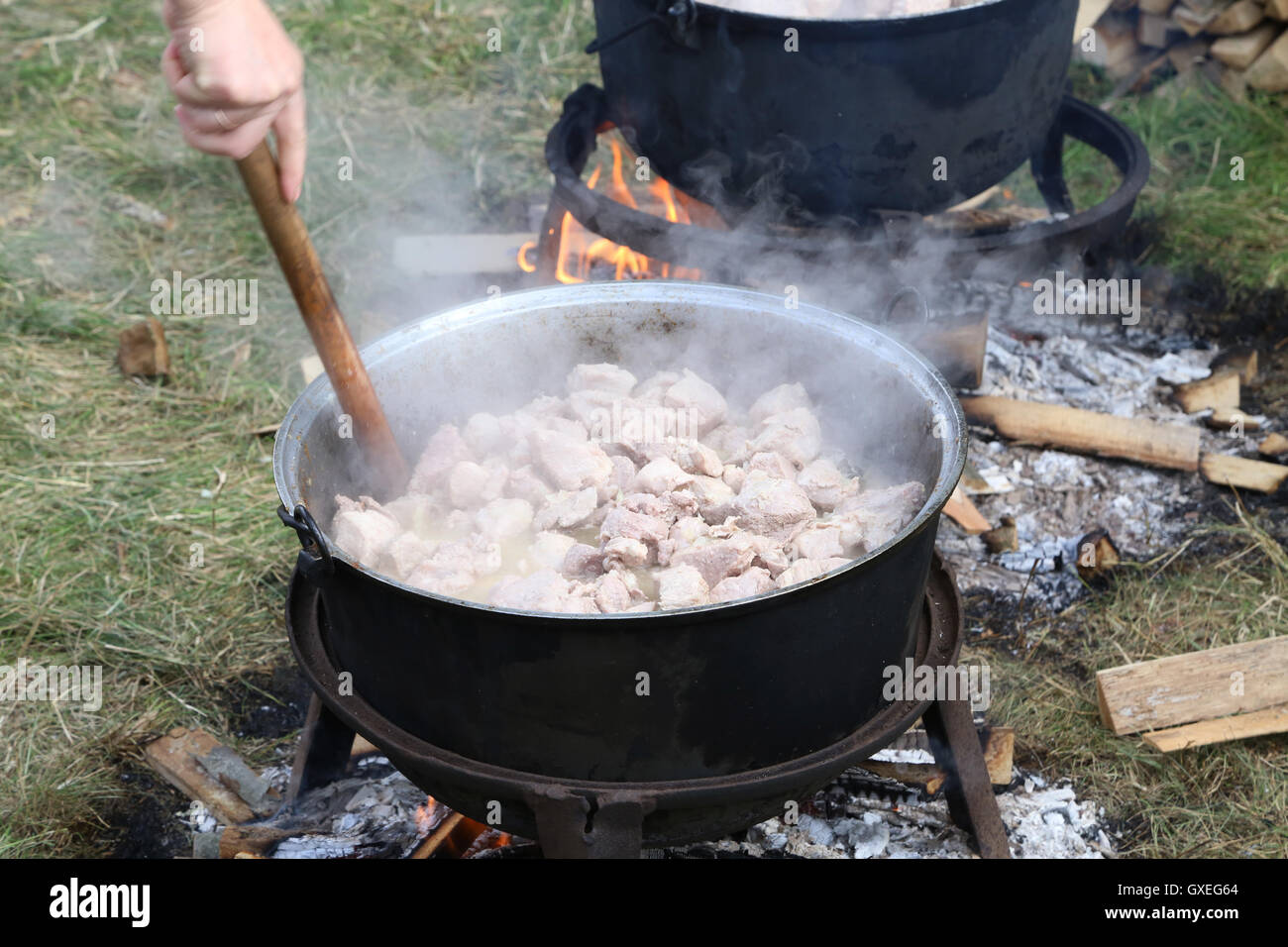 Cooking process in a cauldron Stock Photo - Alamy