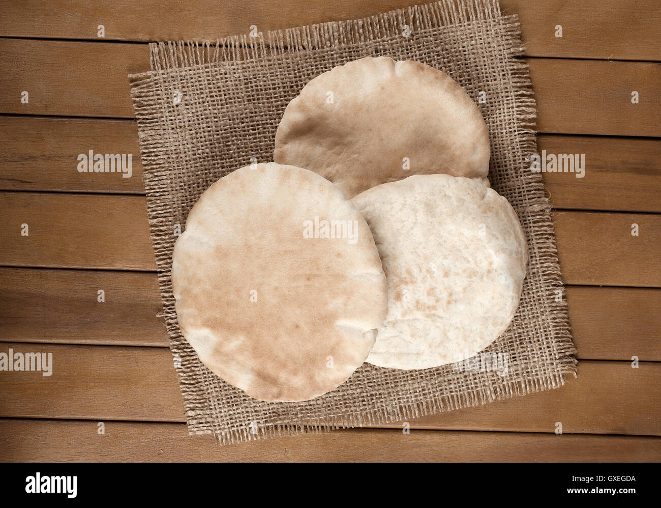 pitta bread (Lebanese Bread), over old burlap background Stock Photo ...