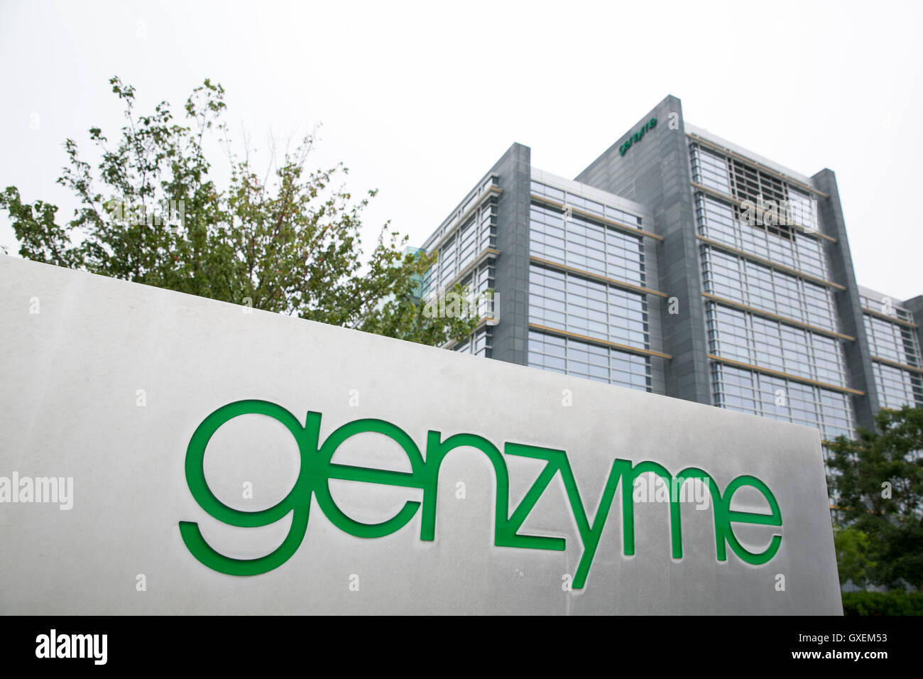 A logo sign outside of a facility occupied by the Genzyme Corporation ...